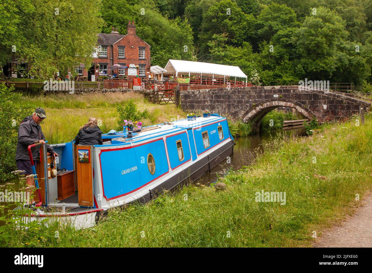 Canal narrowboat moored on the Caldon canal outside the Black Lion pub ...