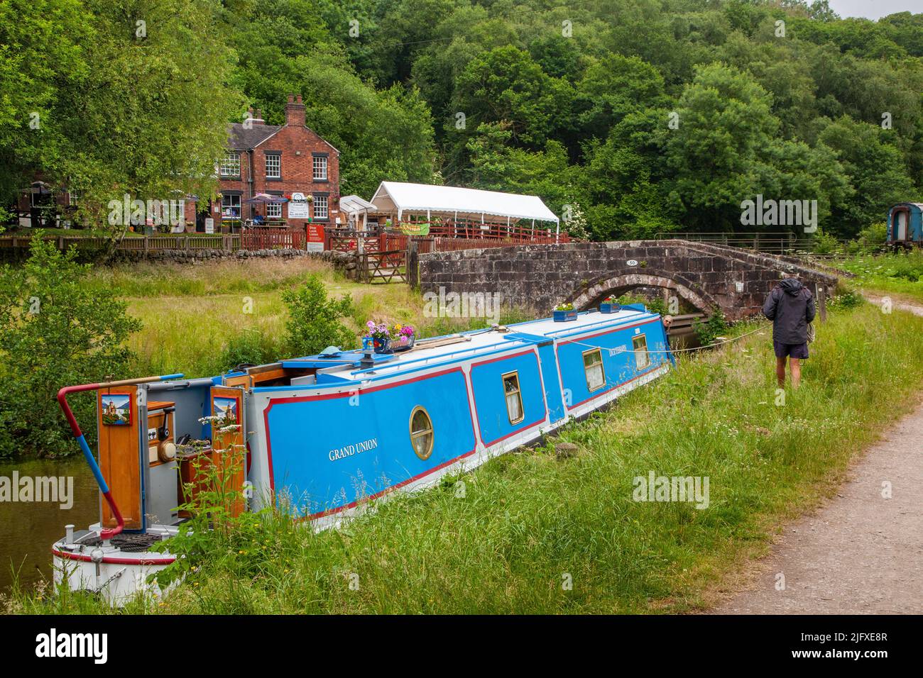 Canal narrowboat moored on the Caldon canal outside the Black Lion pub ...