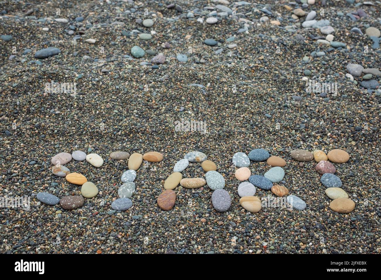 Word start made from stones on sandy beach Stock Photo - Alamy
