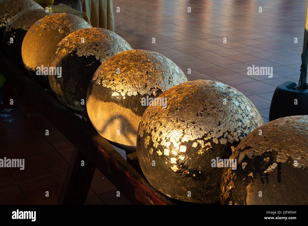 Gold foils pasted on the surface of Luuk Nimit round stones for buried ...