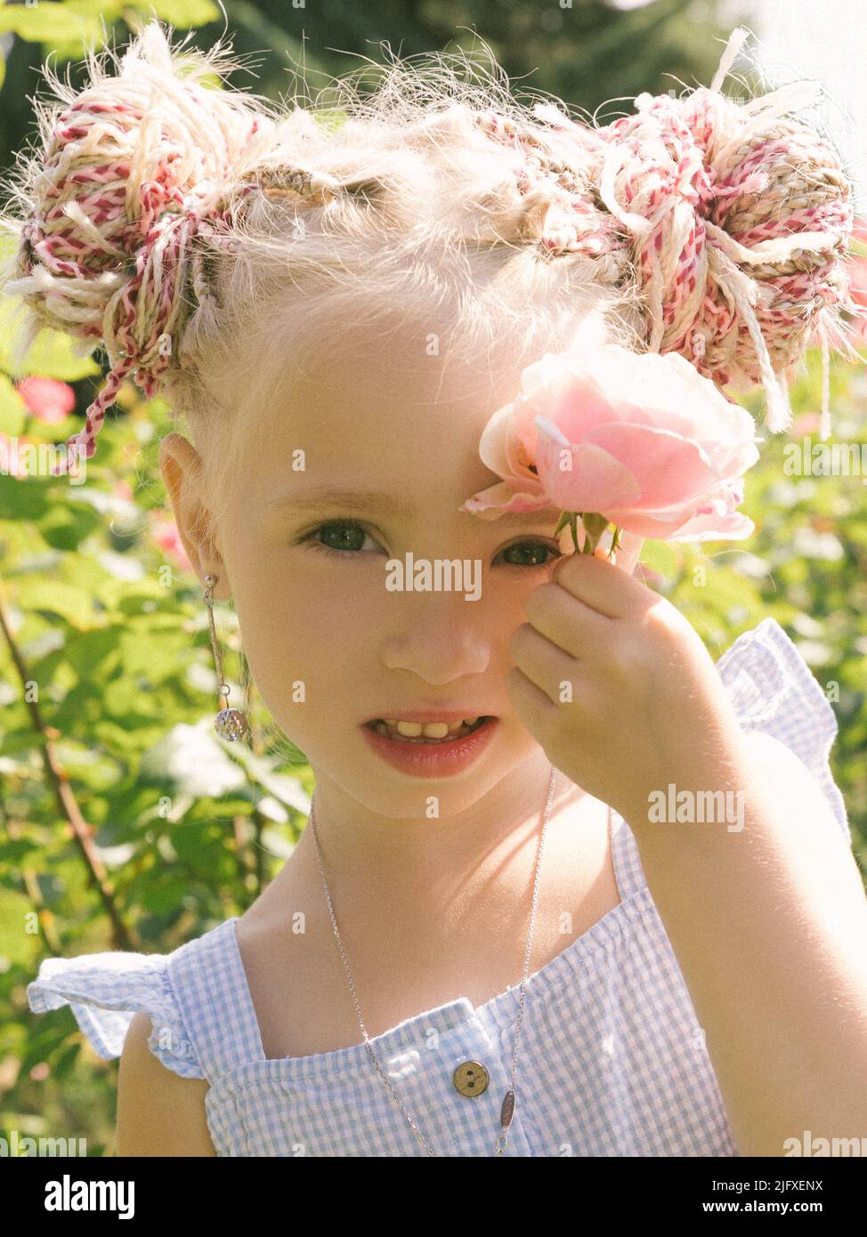 Little girl in the rose garden Stock Photo - Alamy