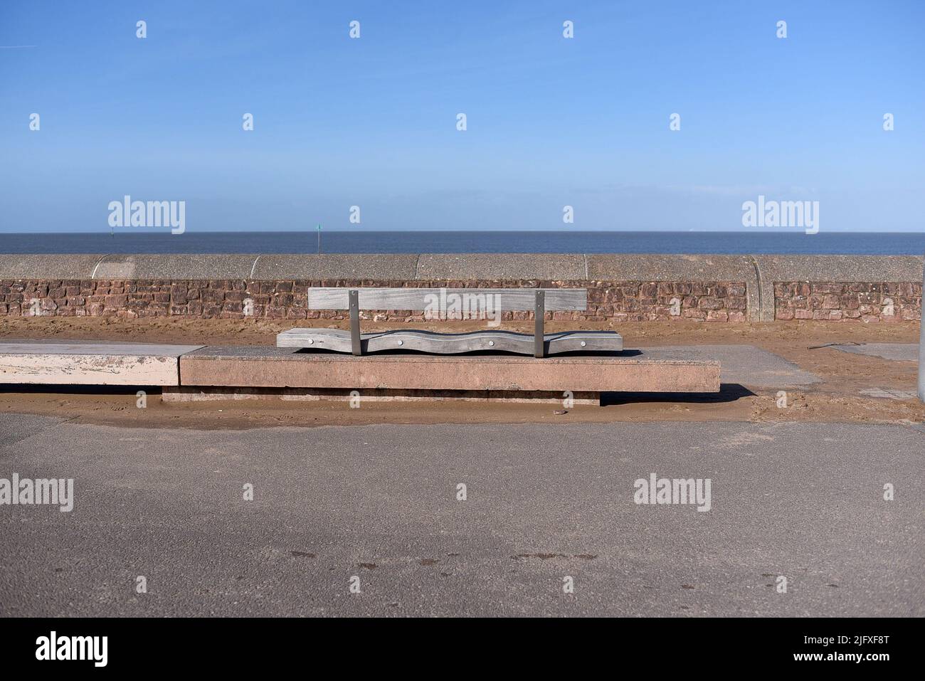 park bench along seafront walk way and sunny holiday Stock Photo - Alamy