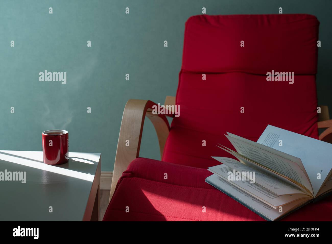 red armchair with an open book on it Stock Photo - Alamy