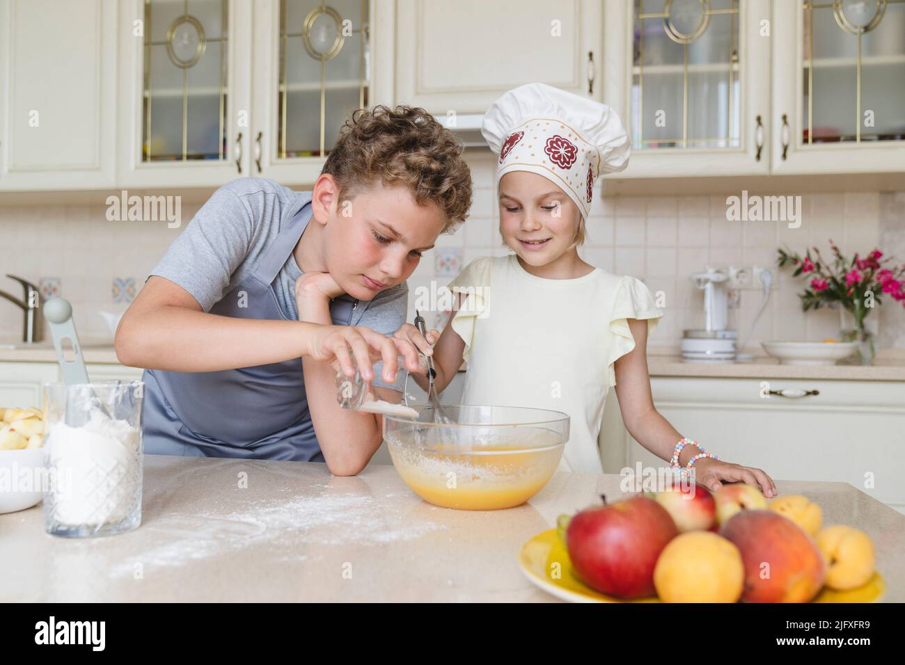 Brother and sister cook apple pie together in the kitchen Stock Photo ...