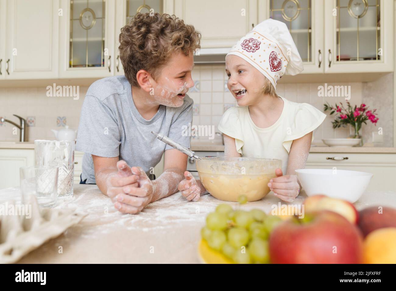 The children are all soiled in flour having fun in the kitchen Stock ...