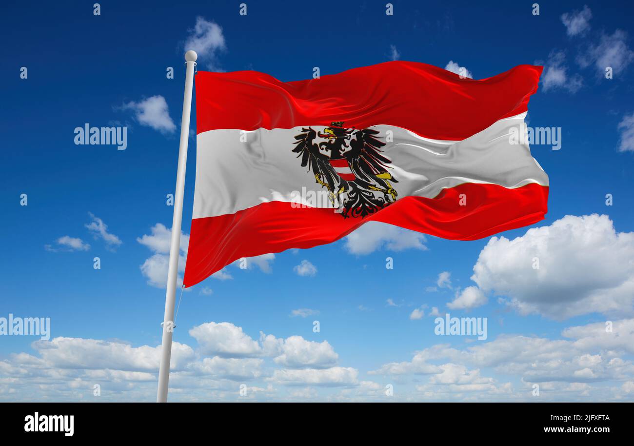 official flag of state Austria at cloudy sky background on sunset ...