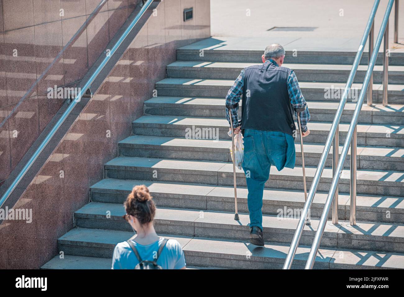 Older man without a leg, invalid or disabled person with crutches ...