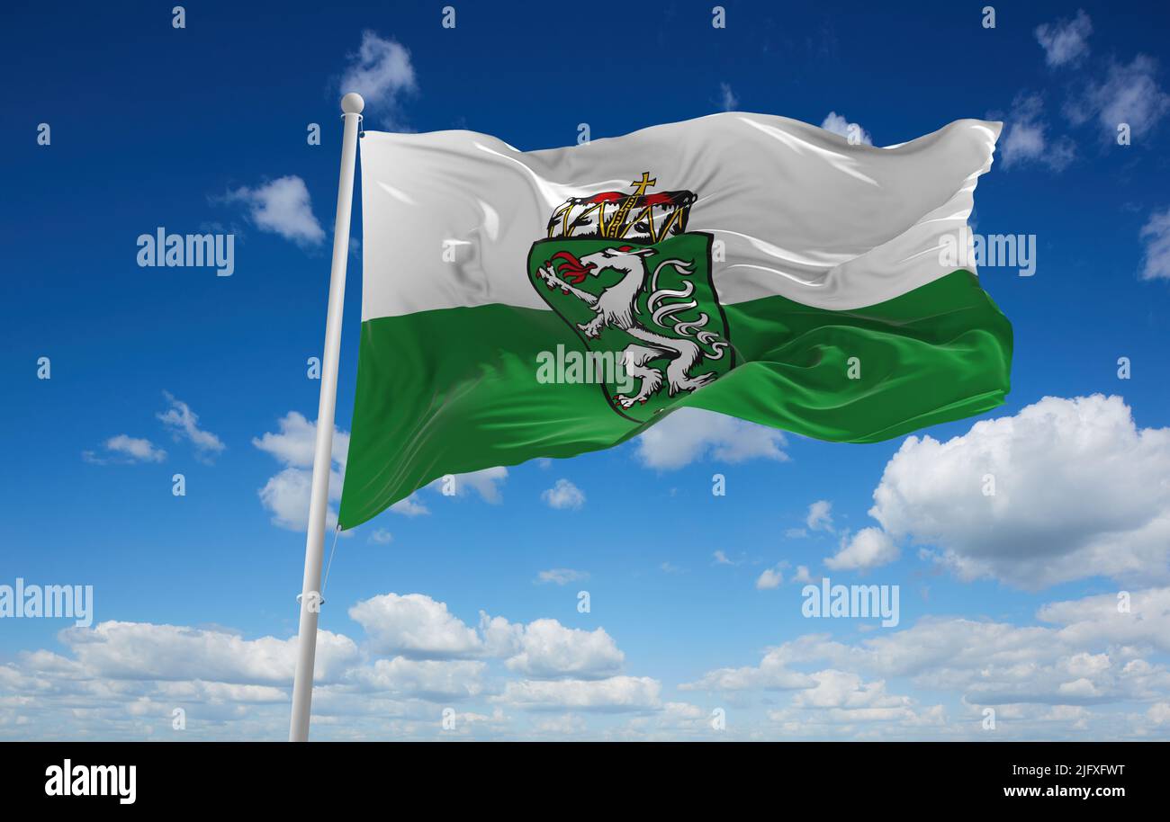 official flag of Styria Austria at cloudy sky background on sunset ...