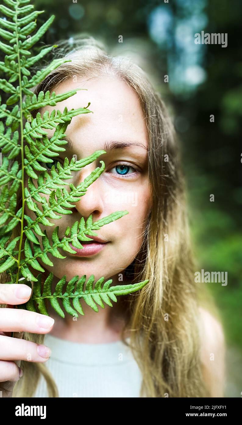 A fern leaf on a girl's face Stock Photo - Alamy