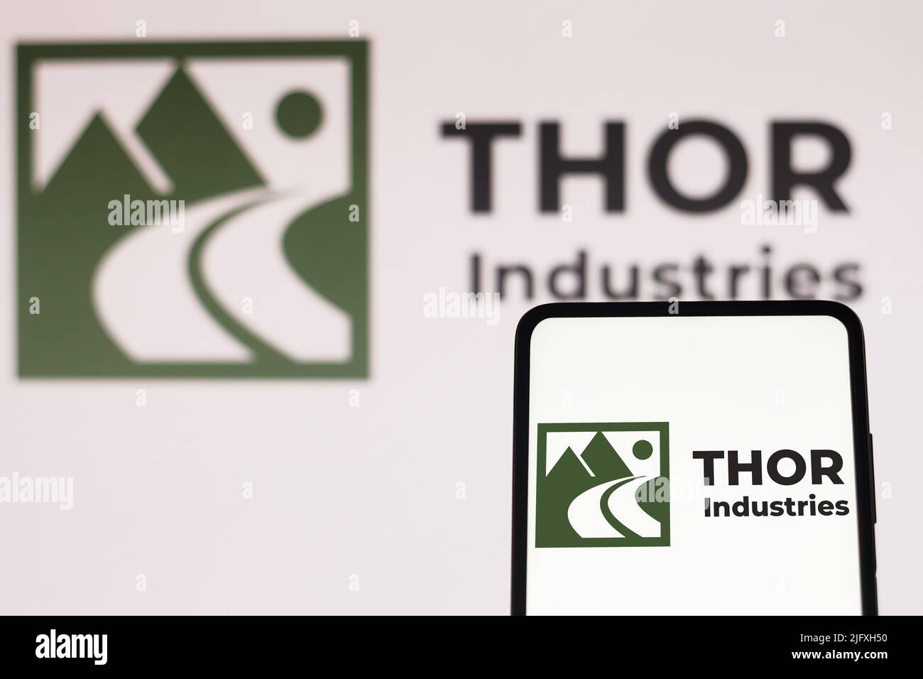 In this photo illustration, the Thor Industries logo is displayed on a ...