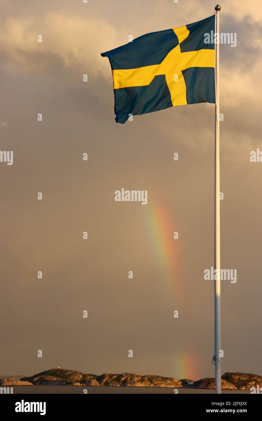 Swedish flag and a rainbow in Fjällbacka archipelago in June 2022 Stock ...