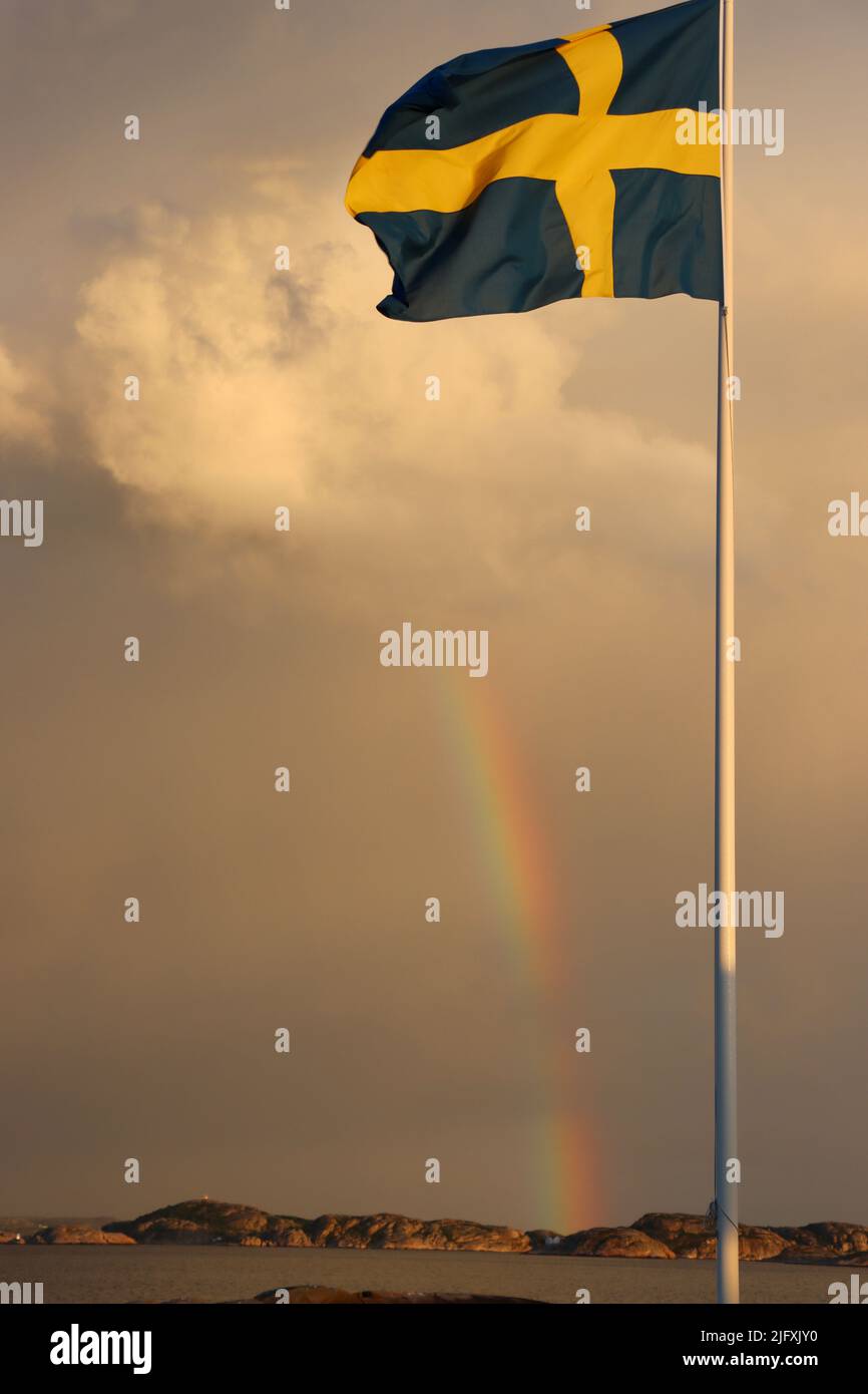 Swedish flag and a rainbow in Fjällbacka archipelago in June 2022 Stock ...