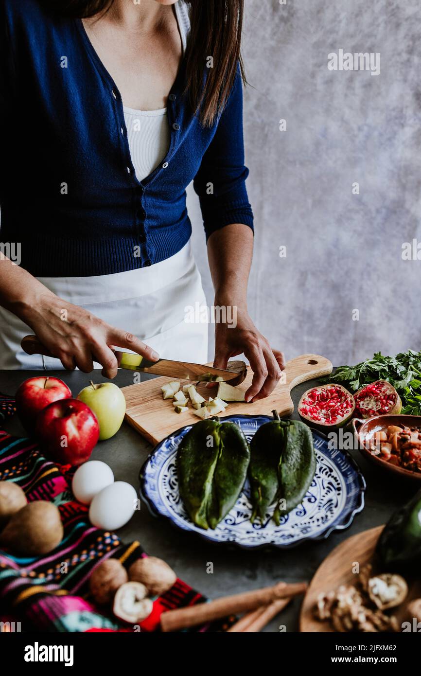 mexican woman cooking chiles en nogada recipe with Poblano chili and ...