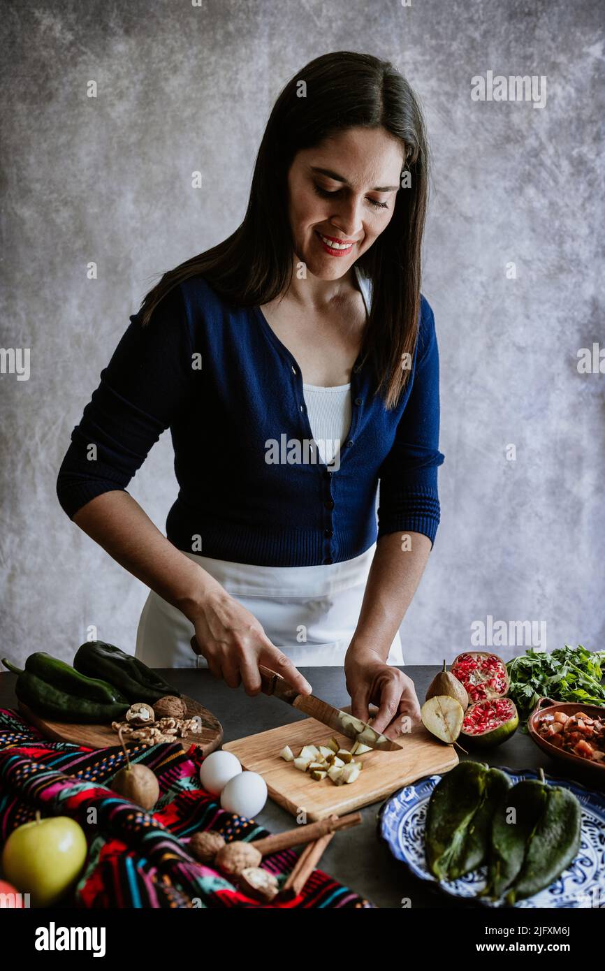 mexican woman cooking chiles en nogada recipe with Poblano chili and ...