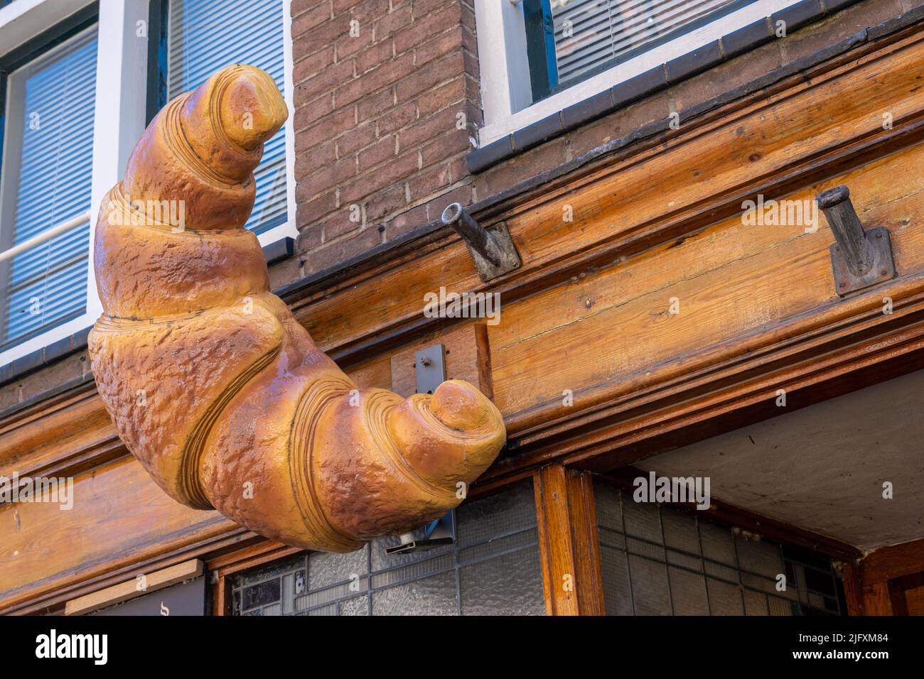Giant croissant on the facade of a bakery Stock Photo - Alamy