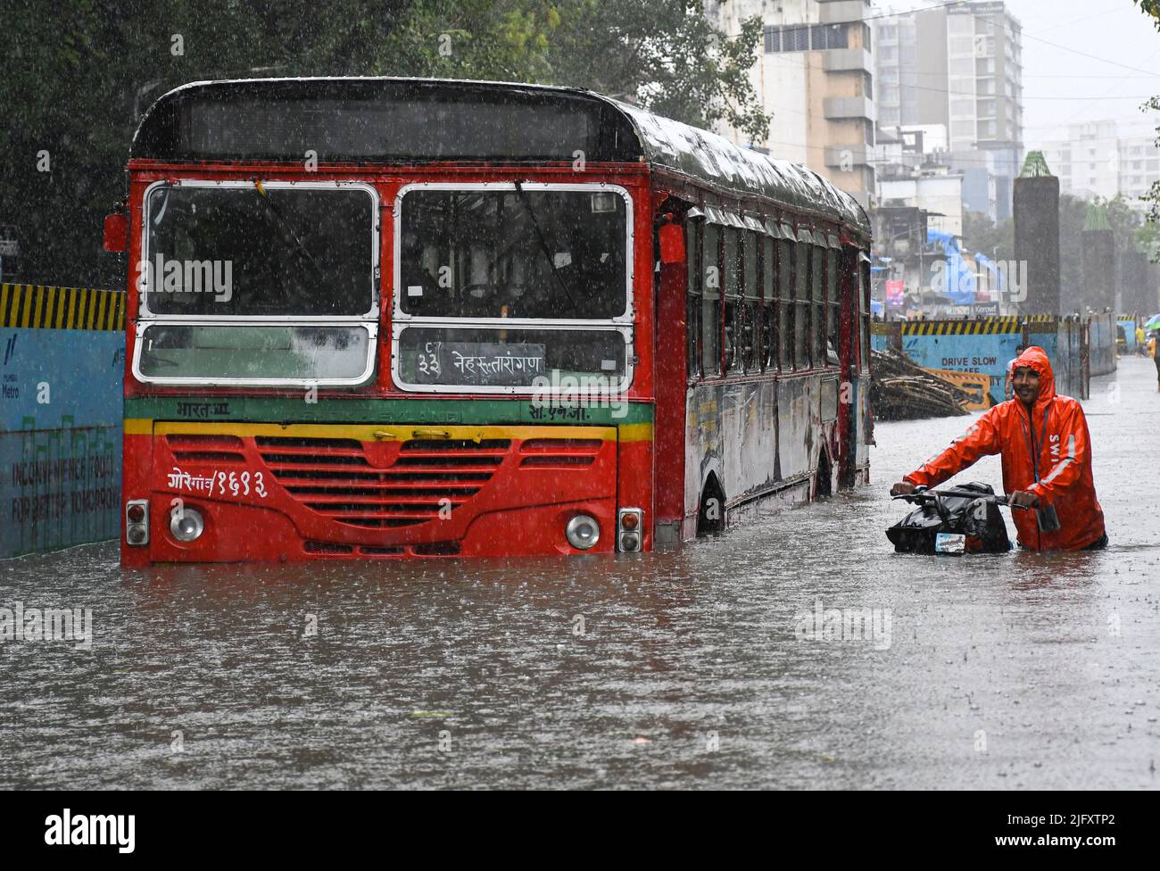 Mumbai, India. 05th July, 2022. A food delivery man is seen pushing his ...