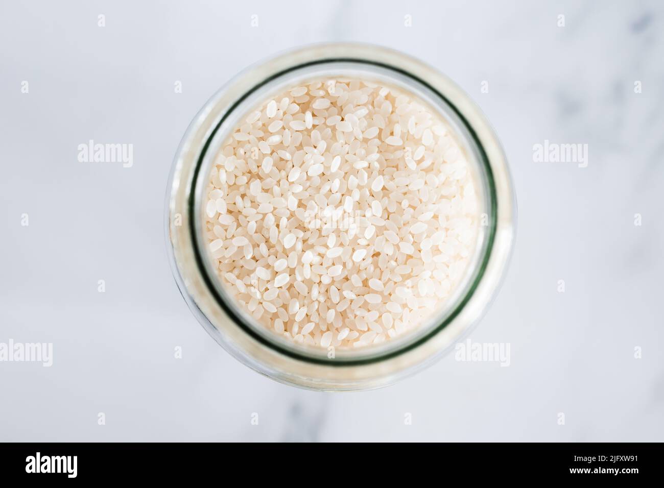 pantry jar with sushi rice shot from top down perspective as close-up ...