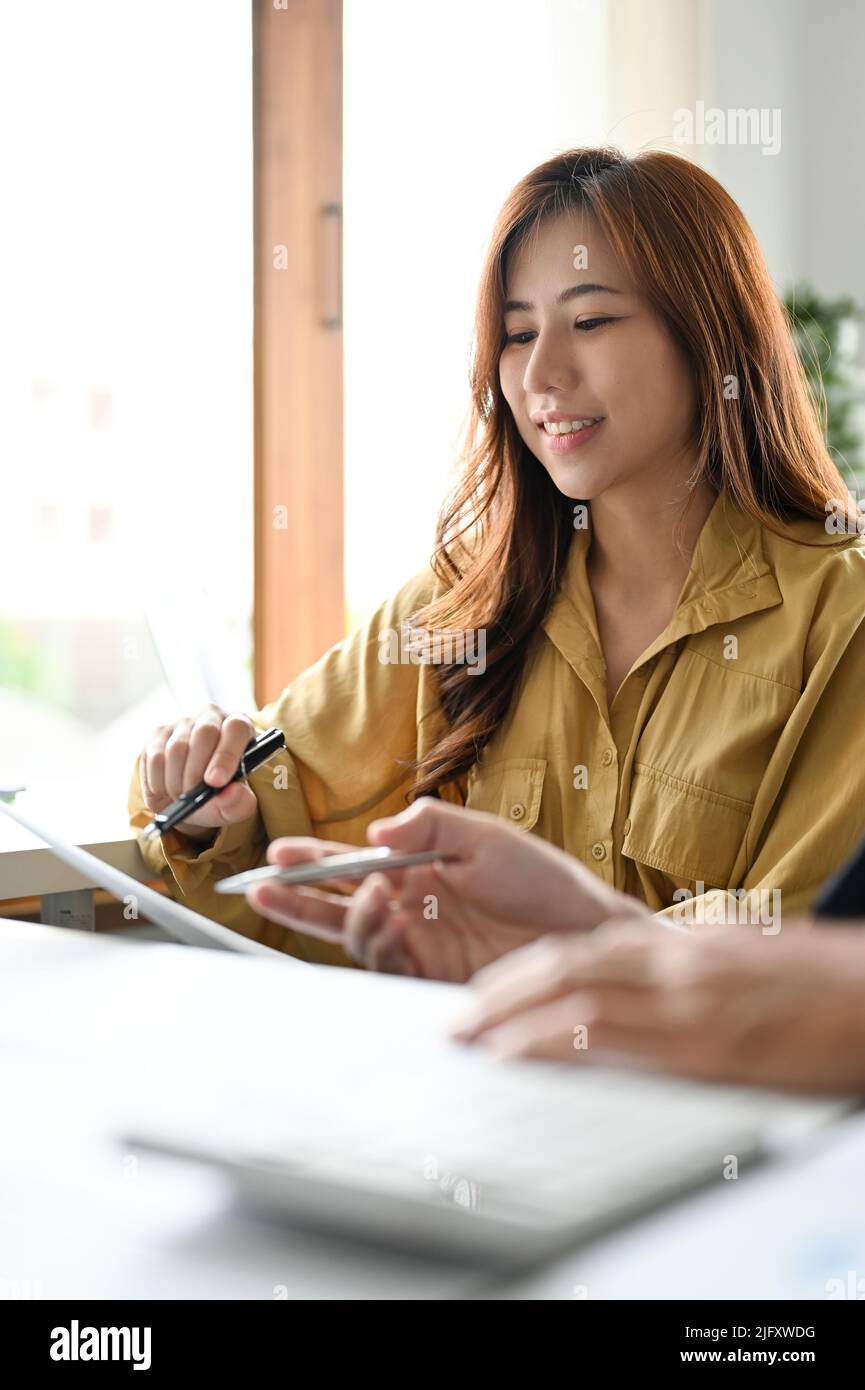 Beautiful attractive millennial asian businesswoman or female officer ...