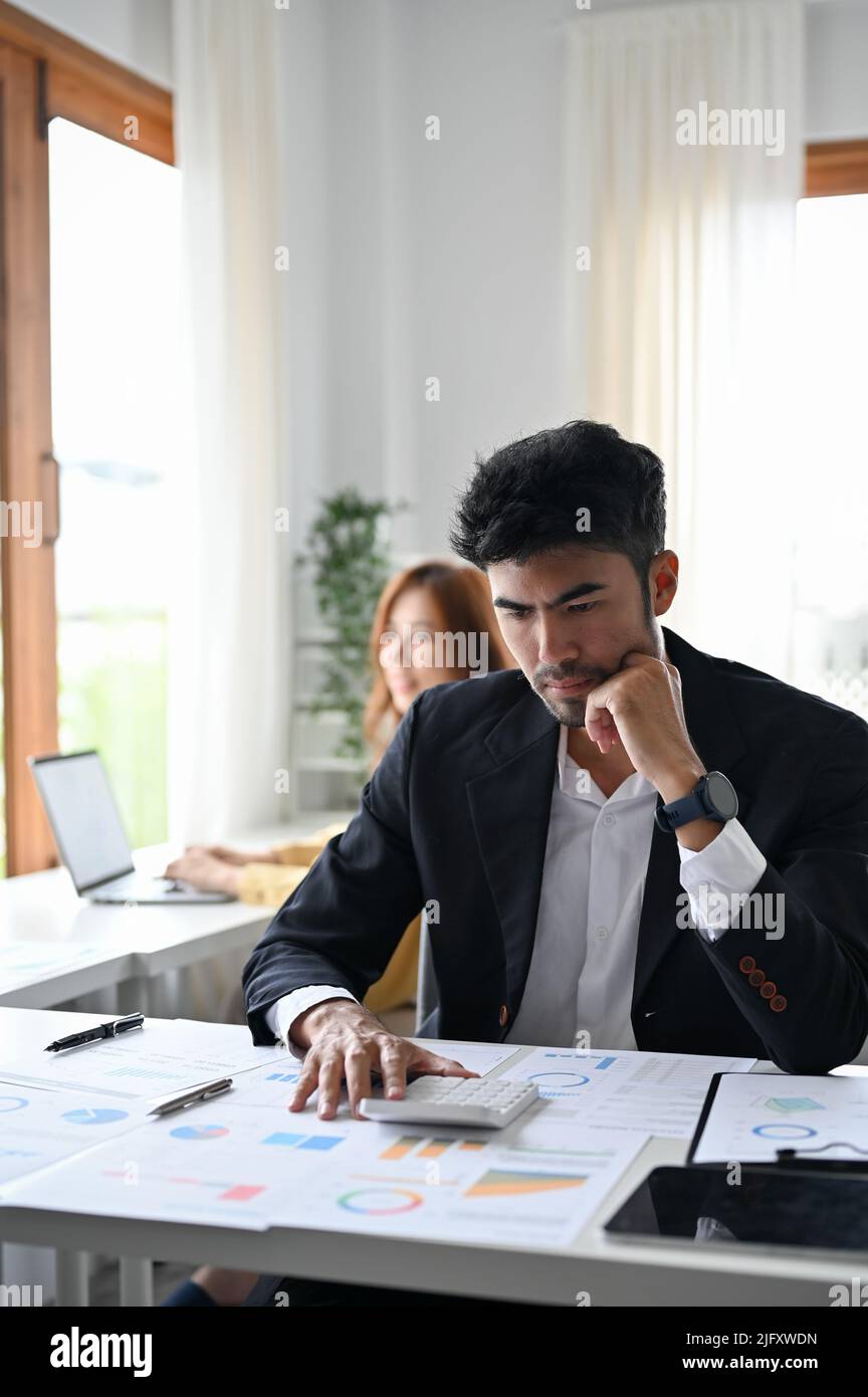 Professional and stressed asian businessman or male financial manager ...