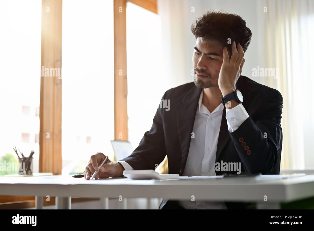 Serious and bored asian businessman or male financial manager in formal ...