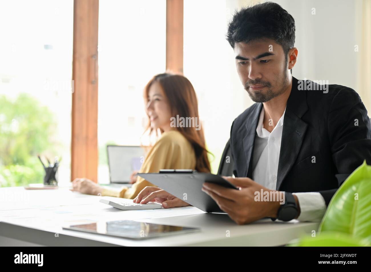Smart asian businessman or male financial worker concentrated and ...