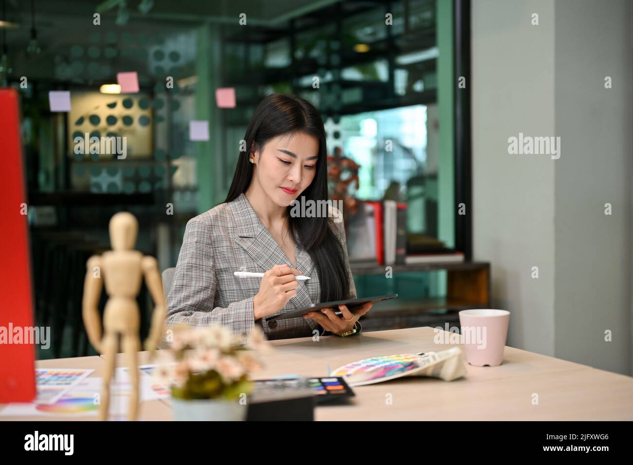 Successful and confident Asian female graphic designer manager using ...