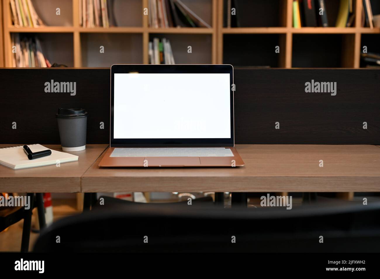 A portable laptop computer white screen mockup on a wood table in ...