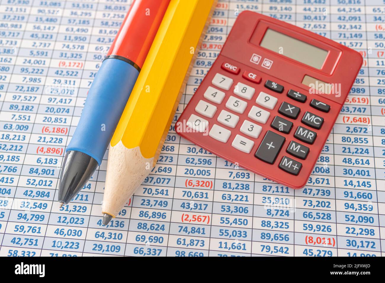 Giant Pencil and Pen with Calculator on Spreadsheet Stock Photo - Alamy