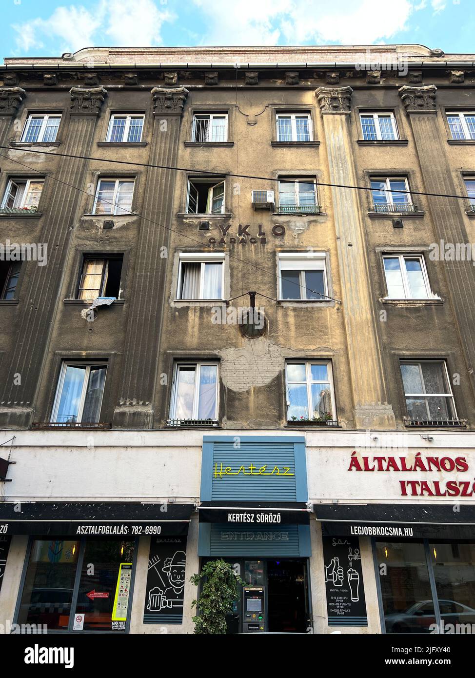 Pub on the ground floor of an old weathered building Stock Photo - Alamy