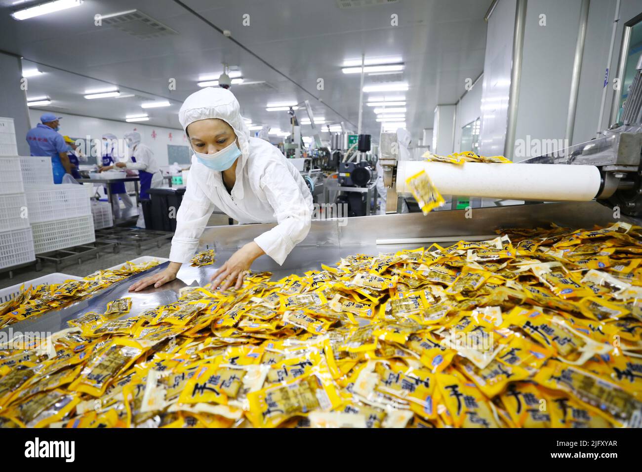 CHONGQING, CHINA - JULY 5, 2022 - Workers spot check the quality of ...