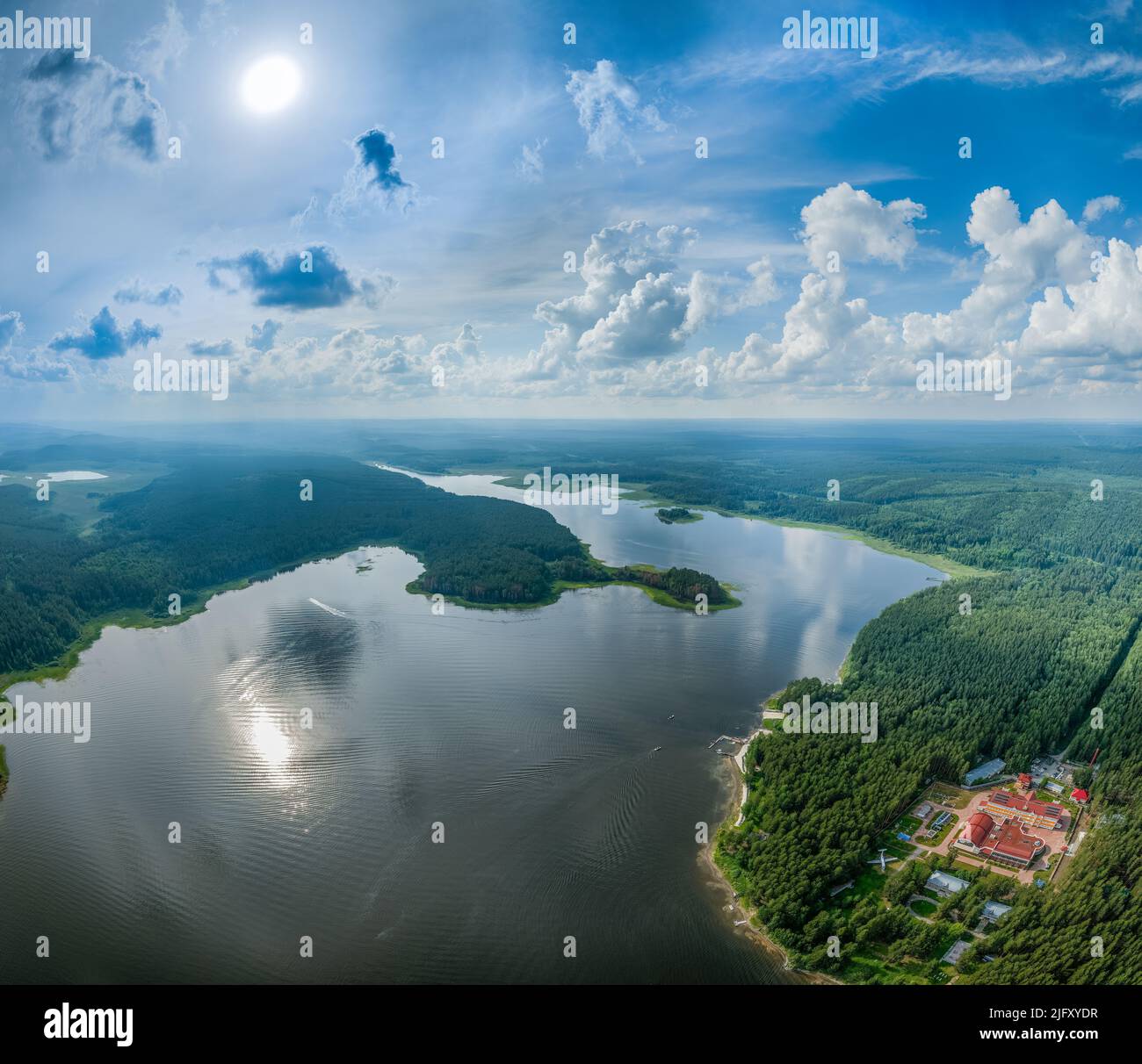 Big lake with green shores in bright sun light, aerial landscape ...