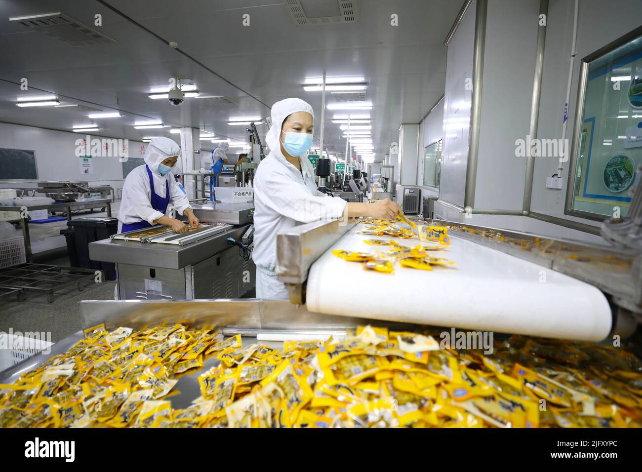 CHONGQING, CHINA - JULY 5, 2022 - Workers spot check the quality of ...