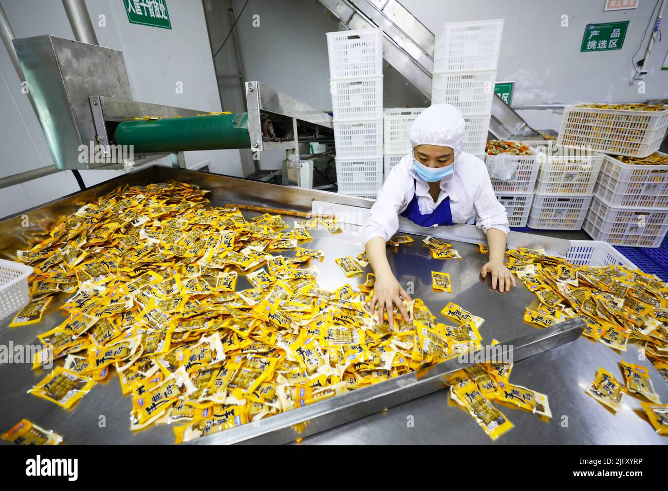 CHONGQING, CHINA - JULY 5, 2022 - Workers spot check the quality of ...