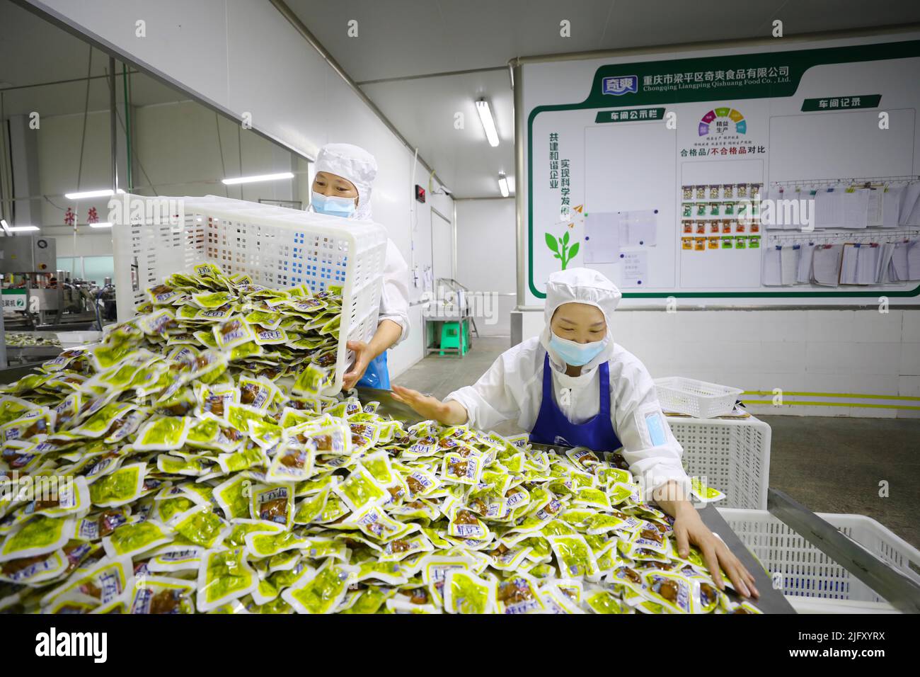 CHONGQING, CHINA - JULY 5, 2022 - Workers spot check the quality of ...