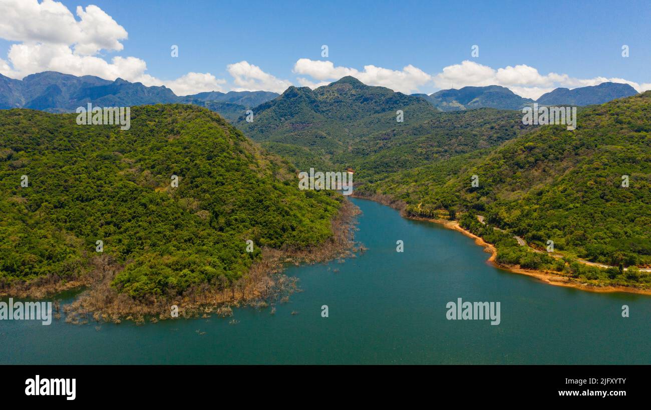 A beautiful lake among the mountains with a green forest. Kalu Ganga ...