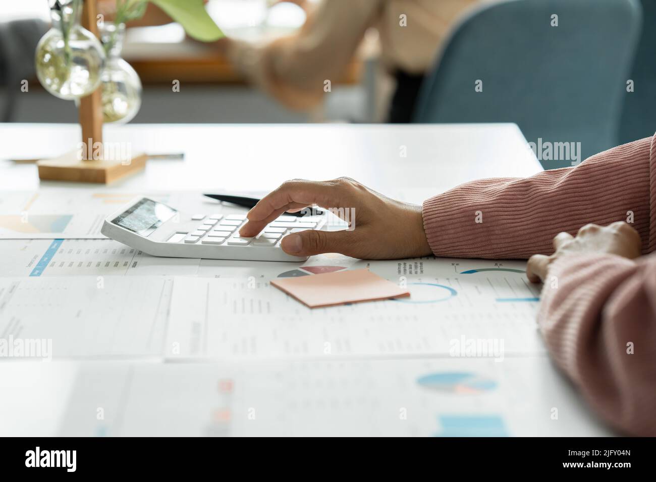 Close up Business woman hand using calculator to calculate the company ...