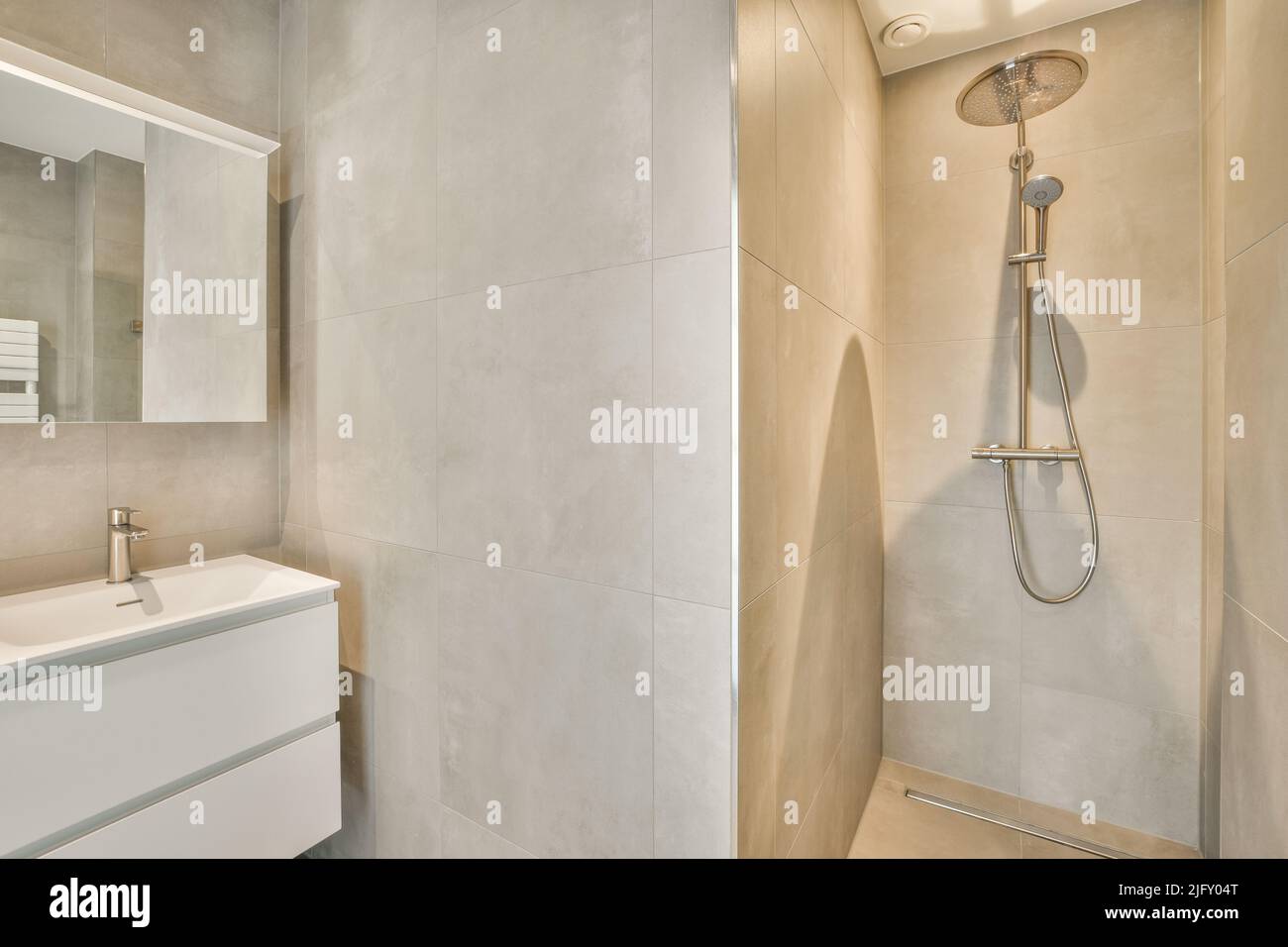 Contemporary bathroom with bathtub and glass shower cabin with light ...