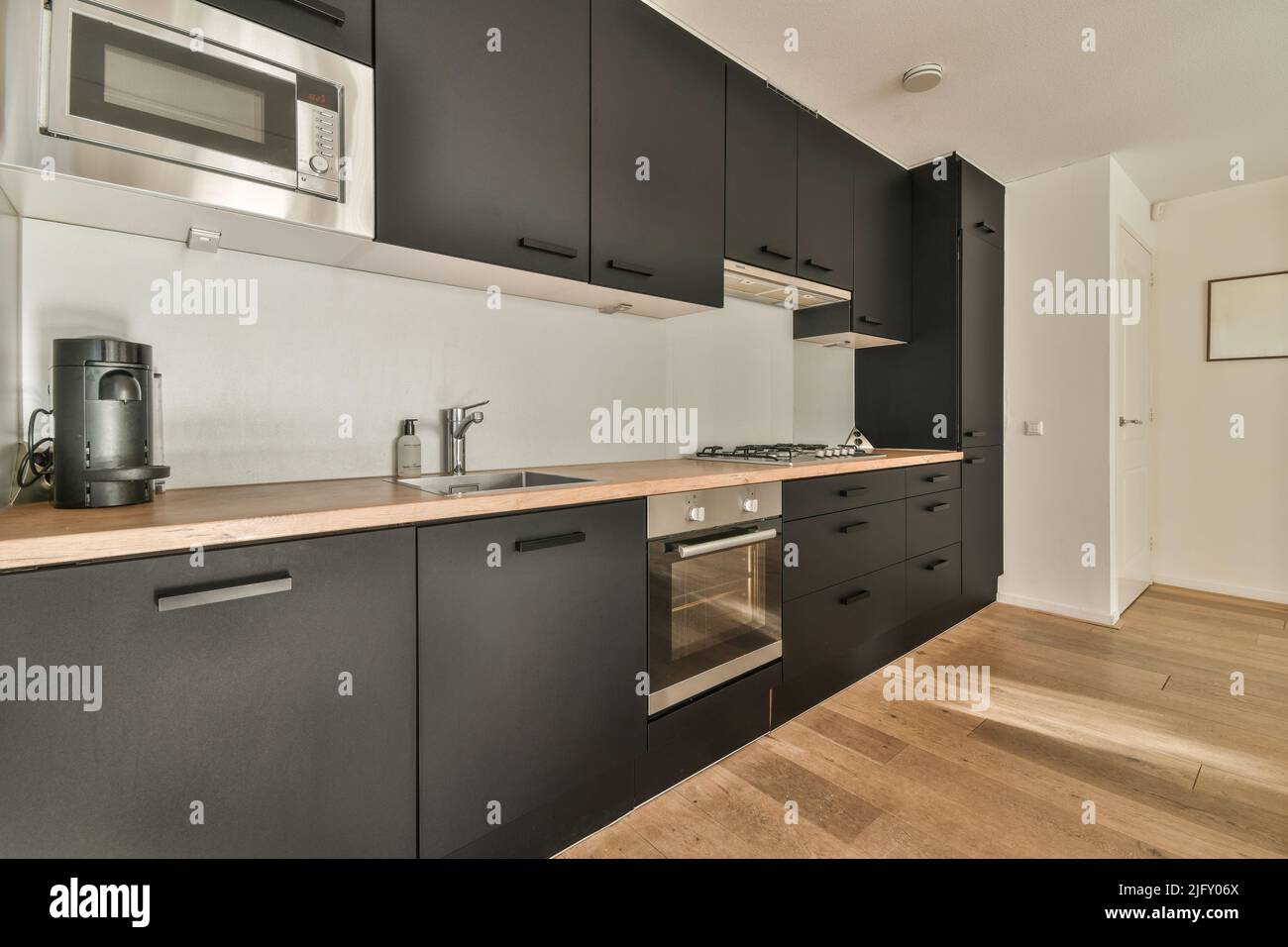 Interior of contemporary kitchen with stylish black cupboards and ...