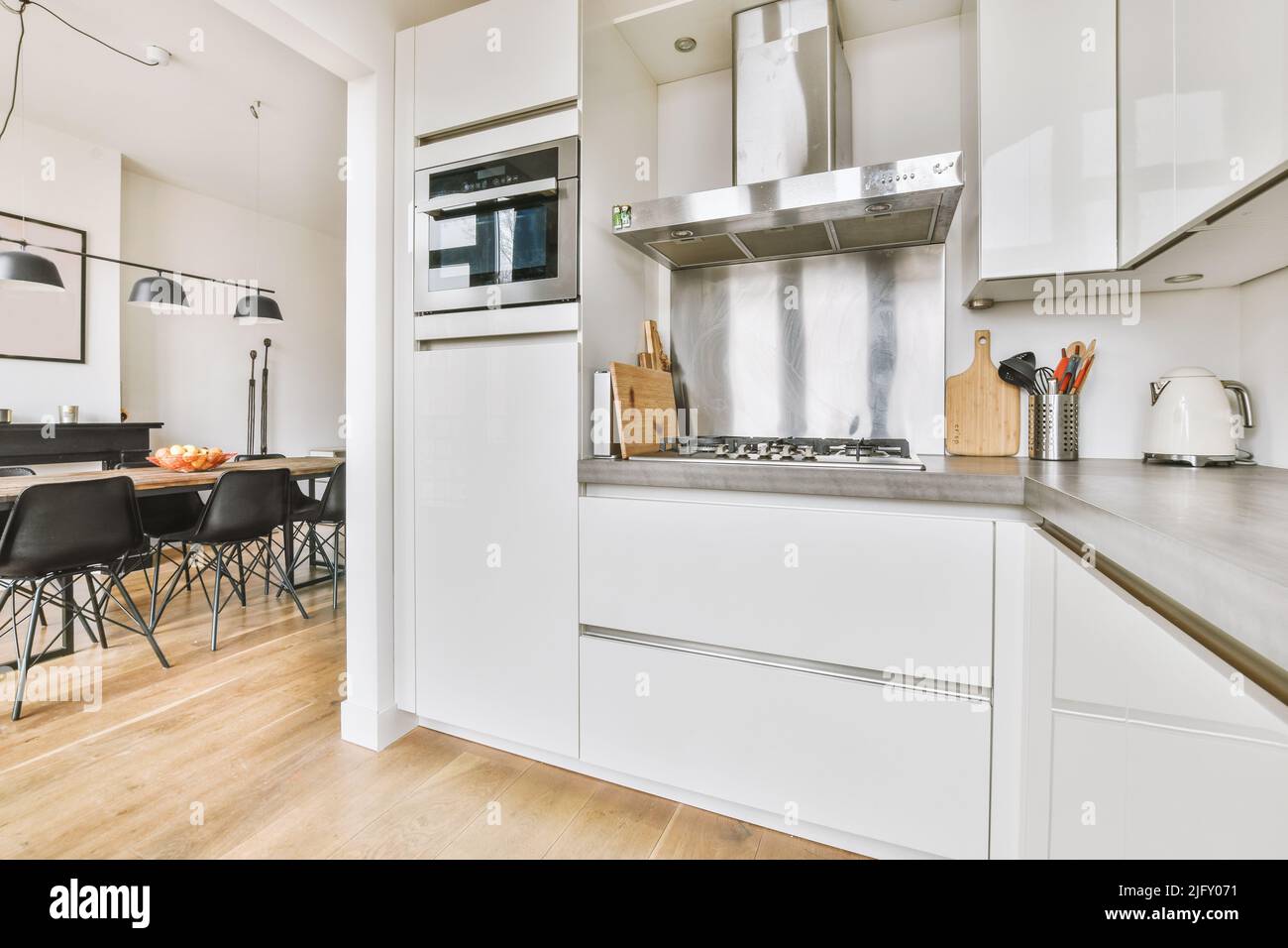 Fragment of interior of light narrow home kitchen with minimalist style ...