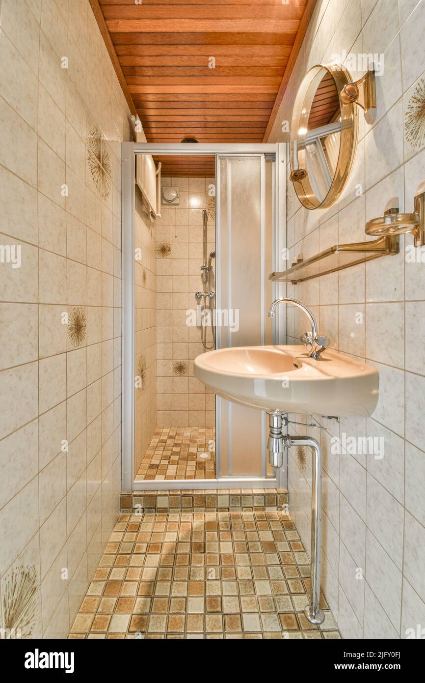 Sinks with mirrors and shower box with glass door in modern bathroom ...