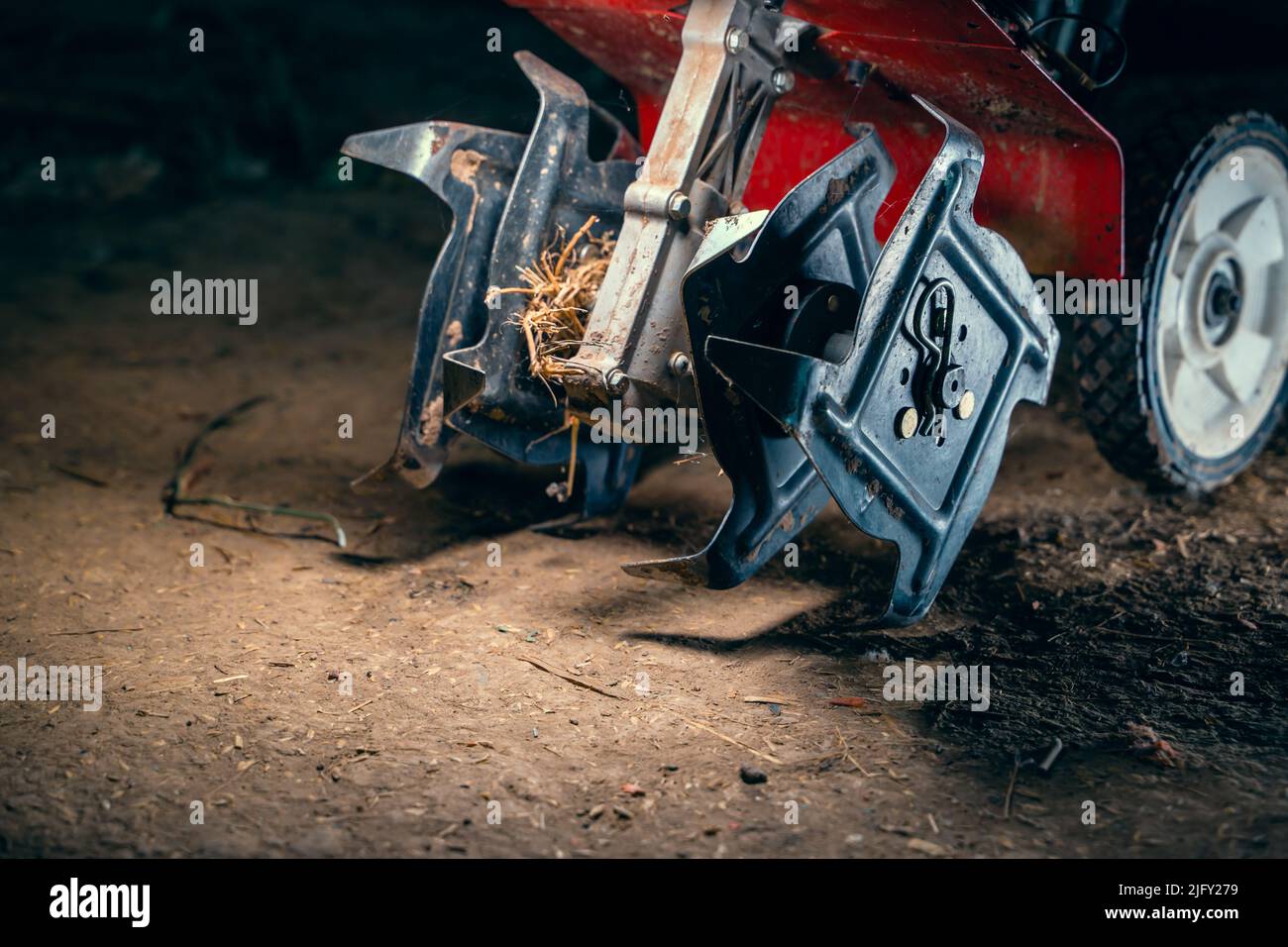 Tiller of a small walk-behind tractor close-up. Manual walk-behind ...