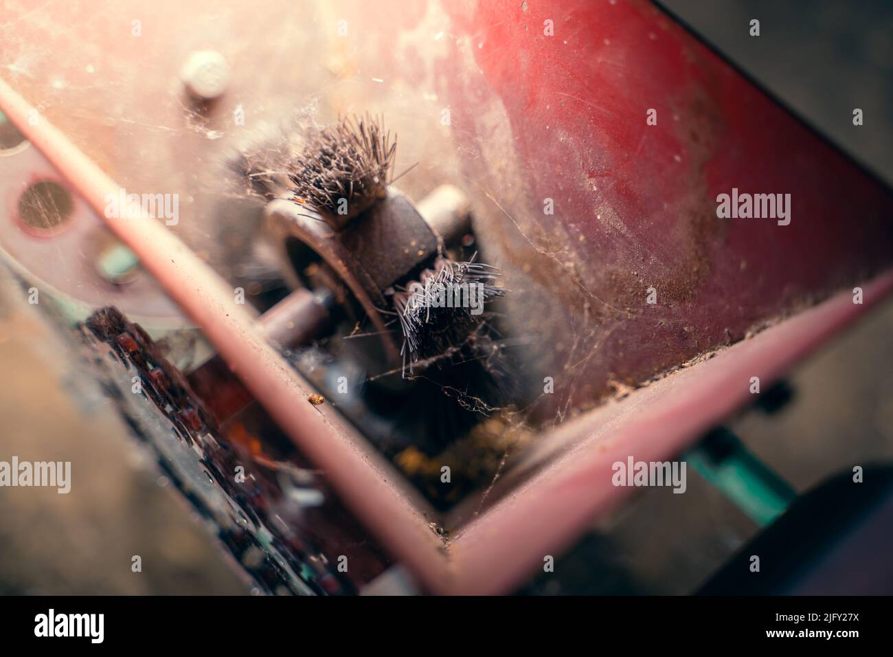 Seed hopper in a manual vegetable seeder close-up. Forgotten old garden ...