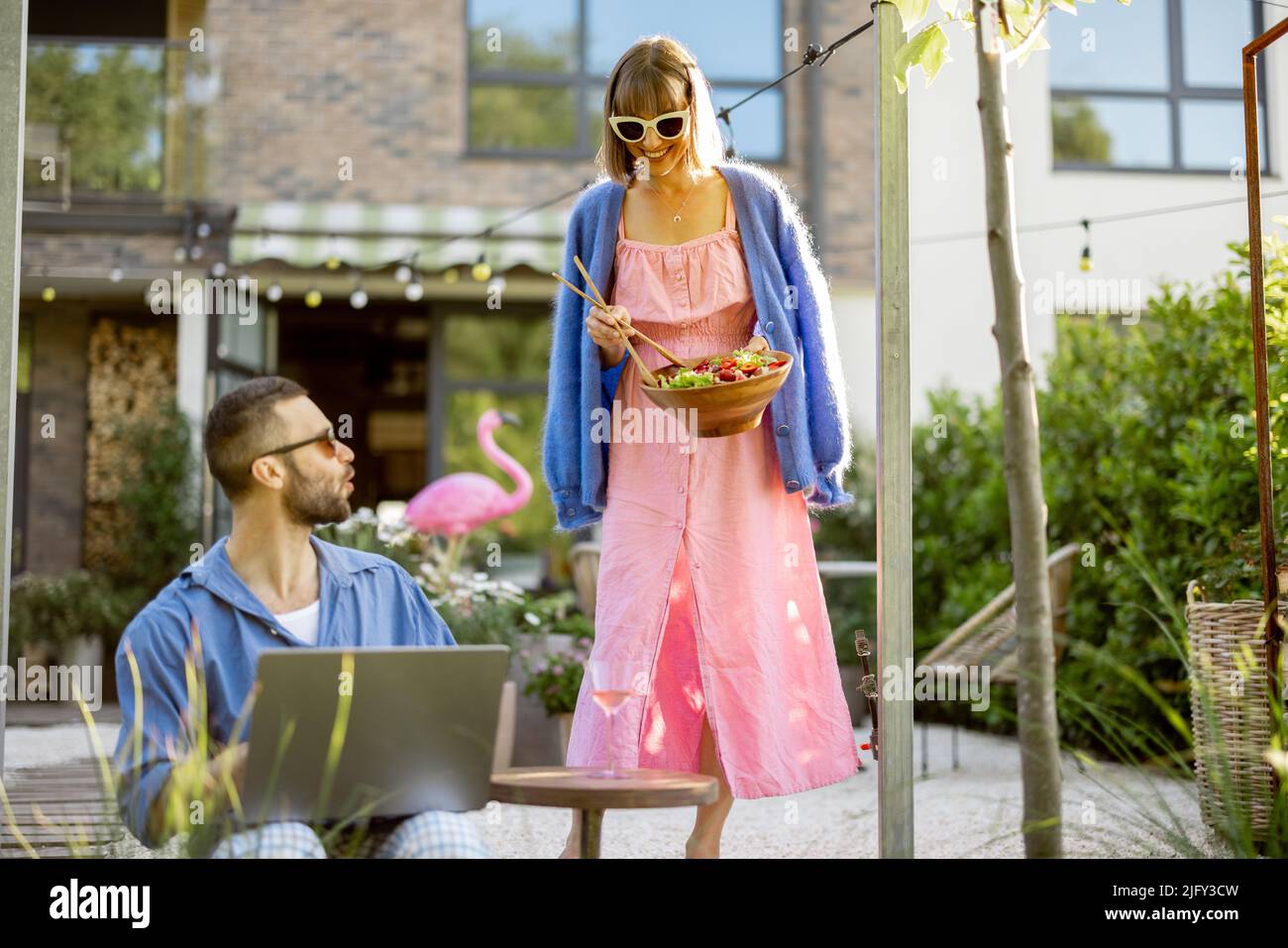 Happy young family with laptop and healthy lunch at backyard Stock ...