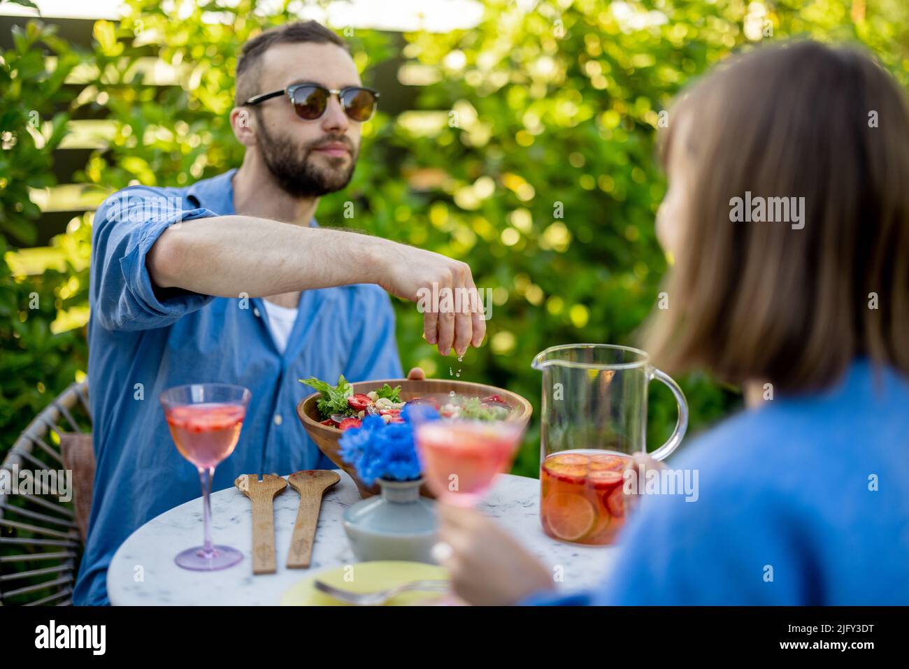 Young family having healthy lunch at backyard Stock Photo - Alamy