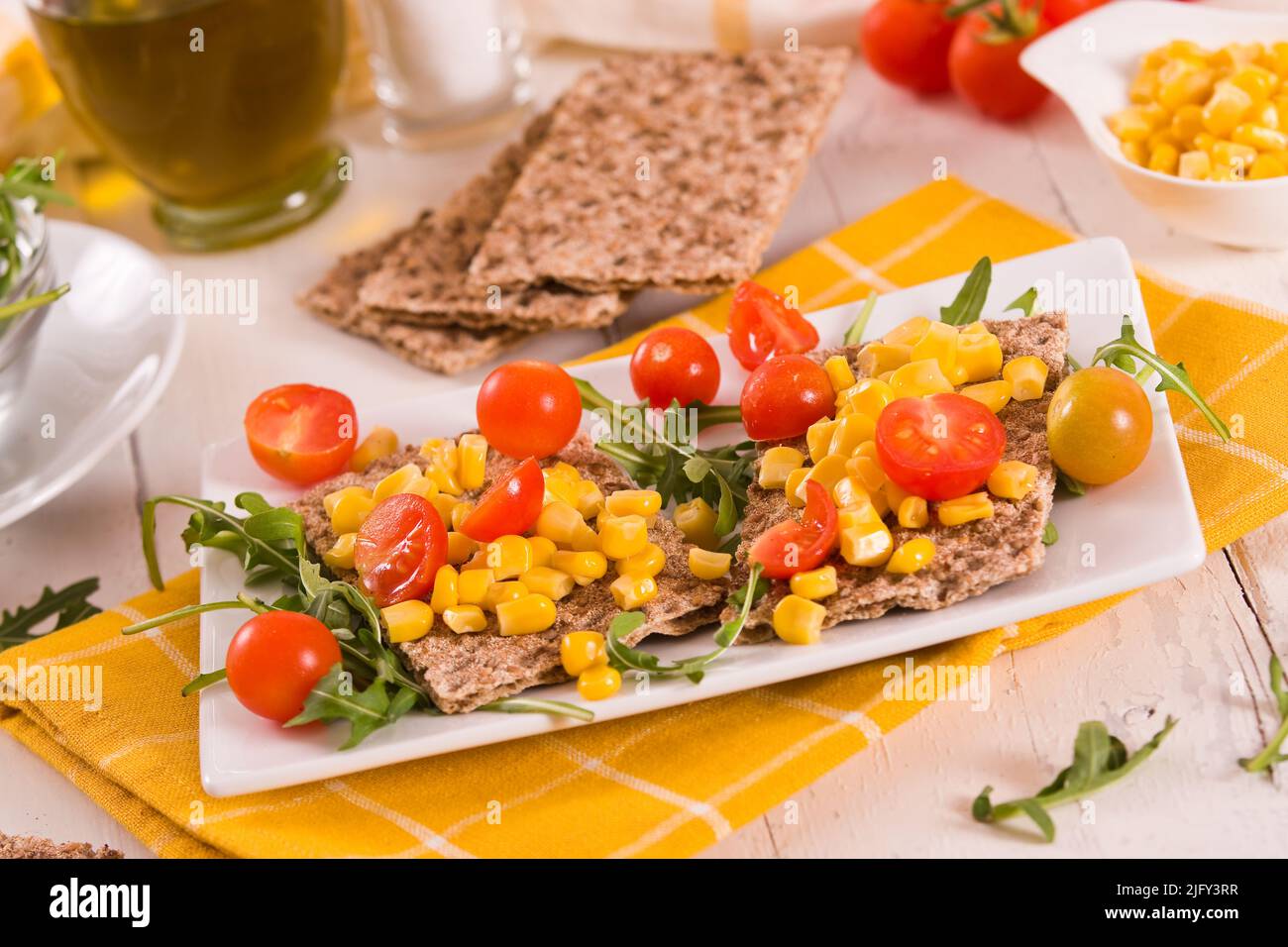Crispy rye bread with sesame seeds, arugula and sweet corn Stock Photo ...