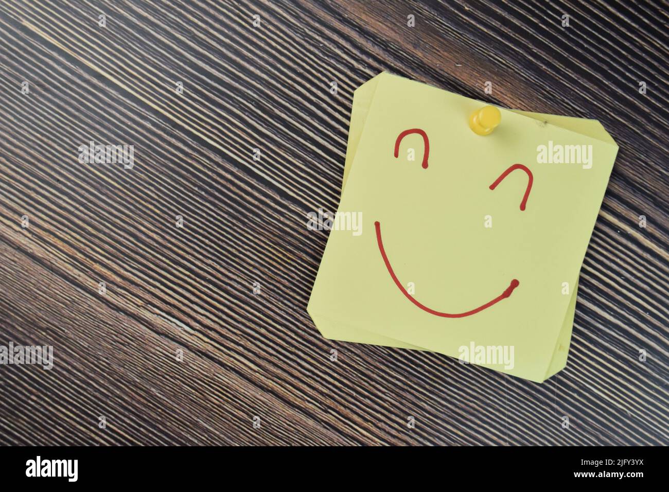 Concept of funny smiley face write on sticky notes isolated on Wooden ...