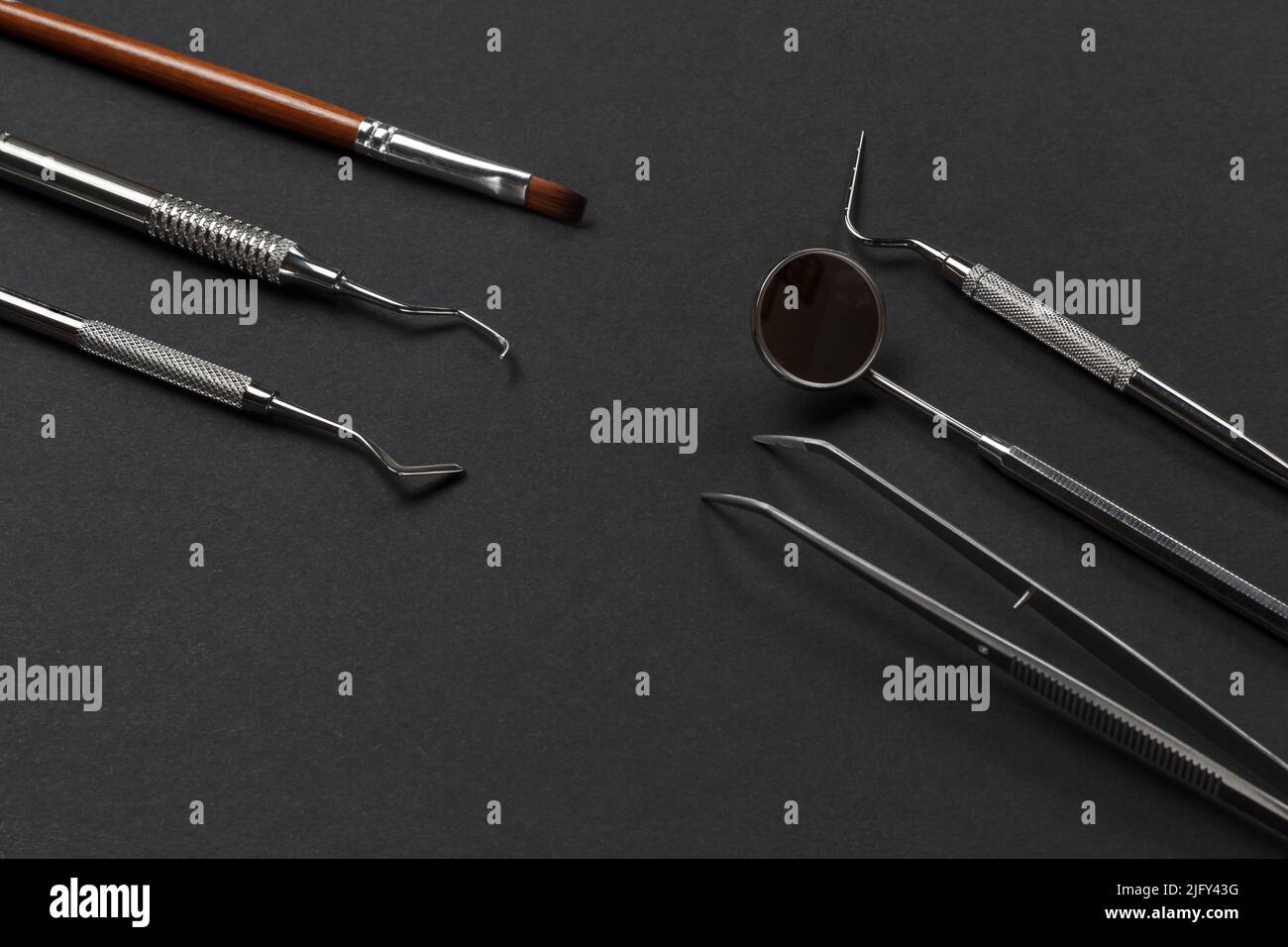 Tweezers, a mouth mirror and a plugger. Dental restoration instrument ...