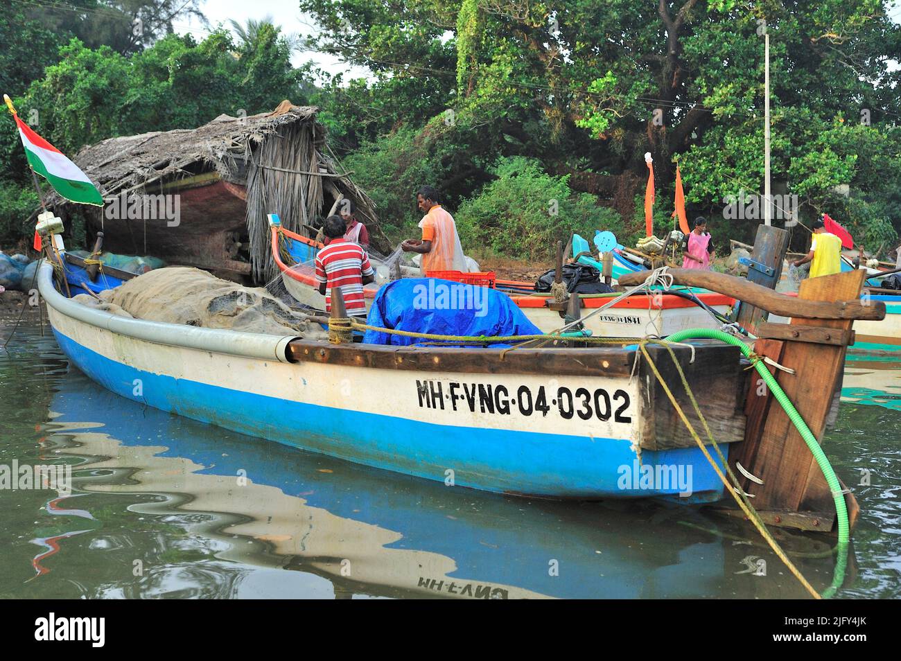 Indian fishermen preparing fishing nets for upcoming voyage at Achara ...