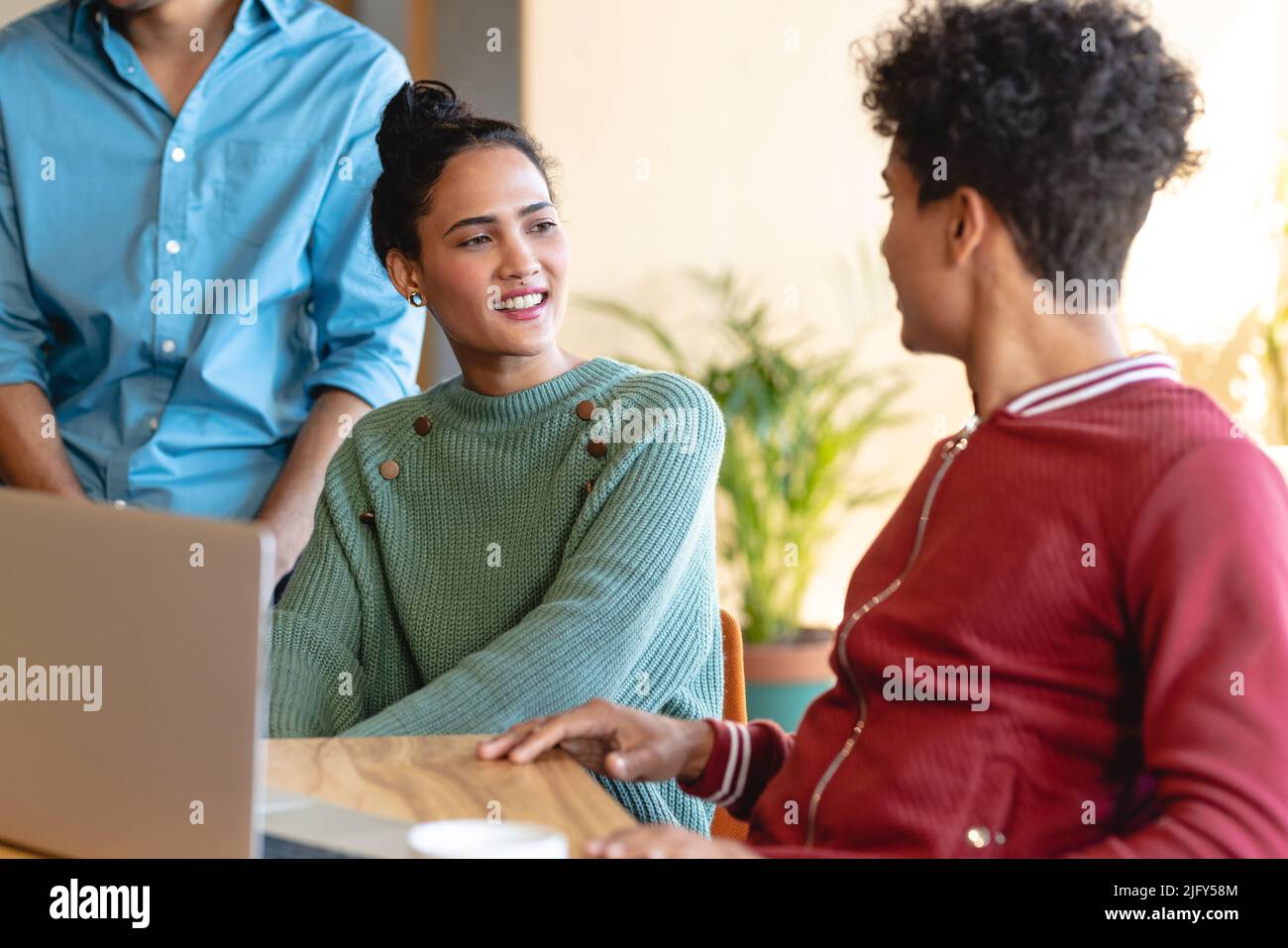 Multiracial male and female design professionals in discussing in ...