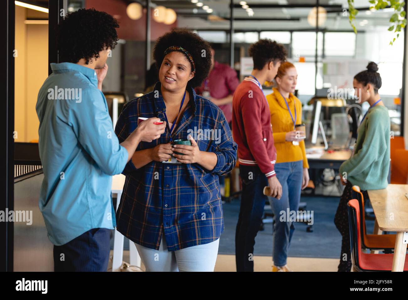 Multiracial male and female design professionals discussing during ...